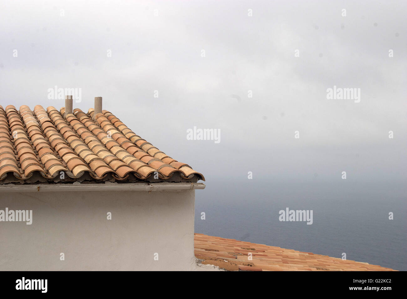a beautiful view of a rooftop with the blue sea in the distance, Palma ...