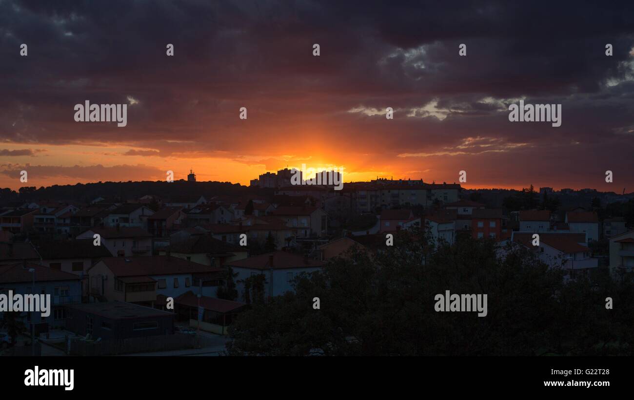 Sunset over village Stock Photo - Alamy