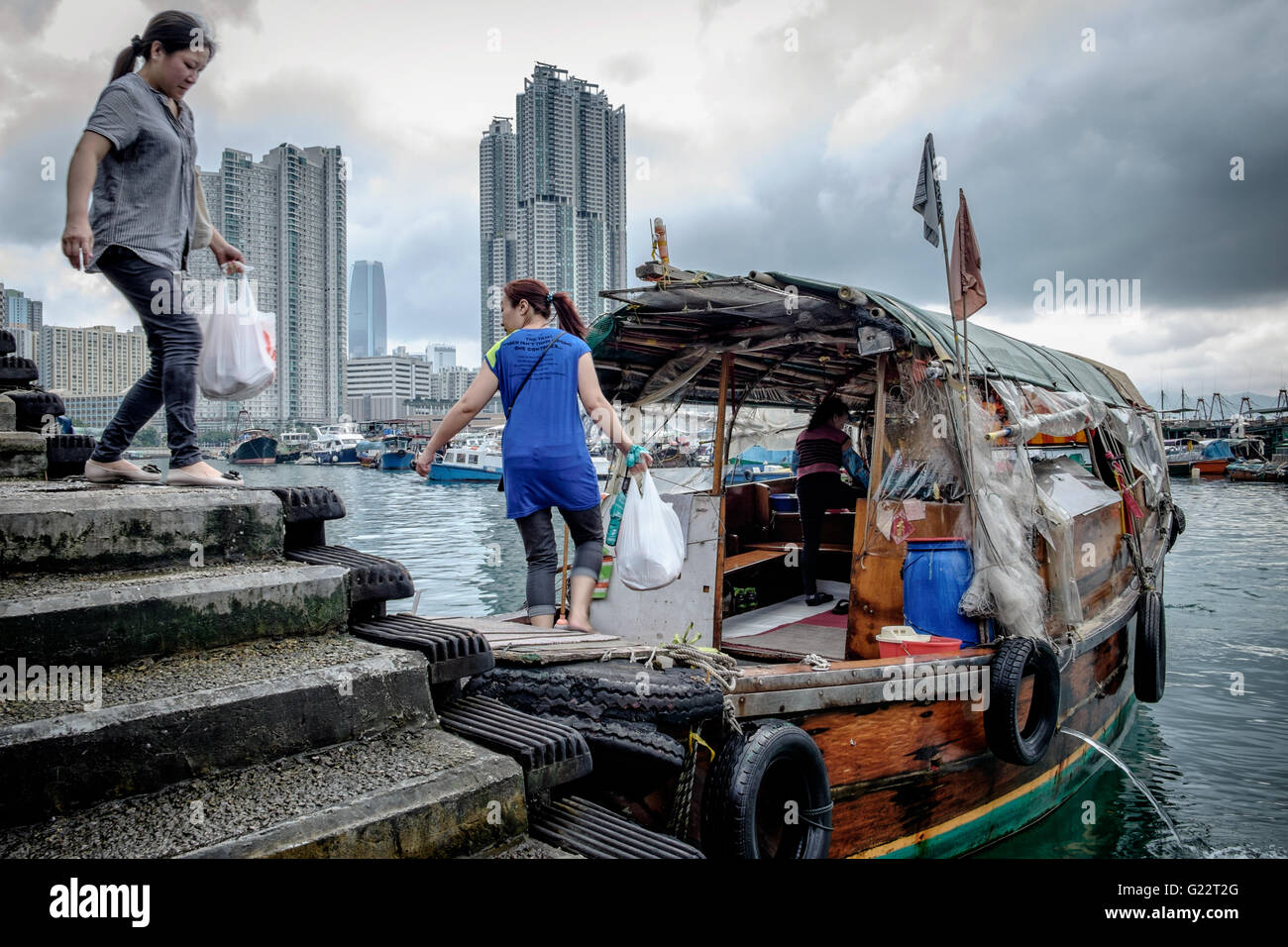 Ladies boarding a sampan in Sai Wan Ho, Hong Kong Stock Photo - Alamy