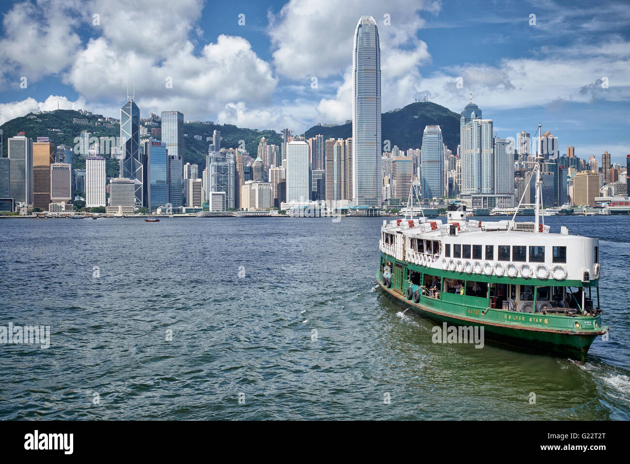 A Star Ferry leaves the Tsim Sha Tsui ferry pier and heads across the Victoria Harbour to ...