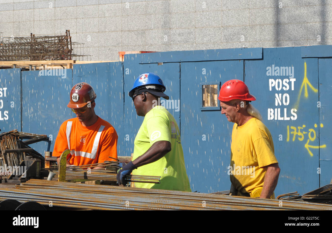 New York, Long Island City. Office building construction, wokers cut ...