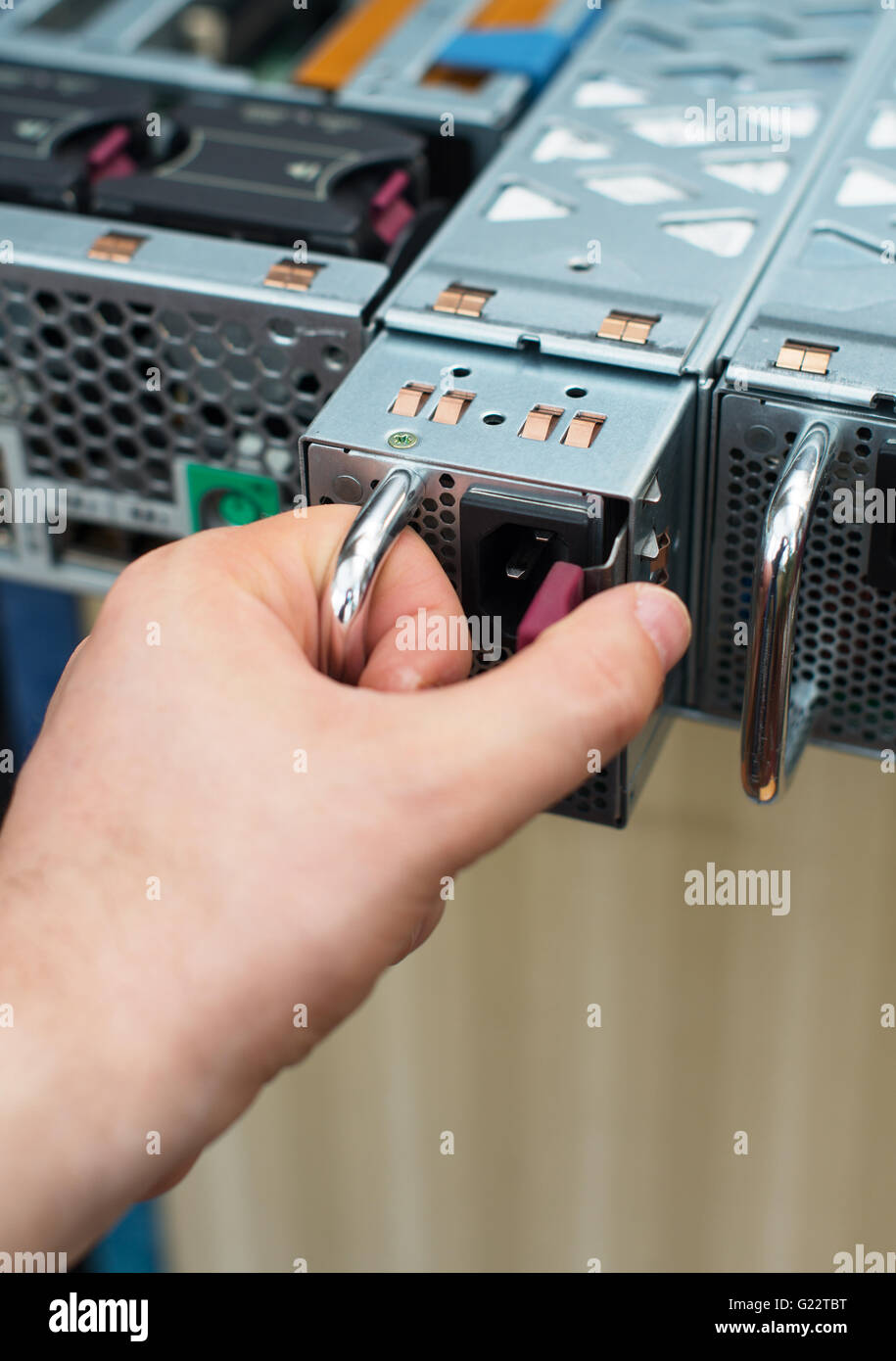 Computer technician installing power supply unit on server Stock Photo ...