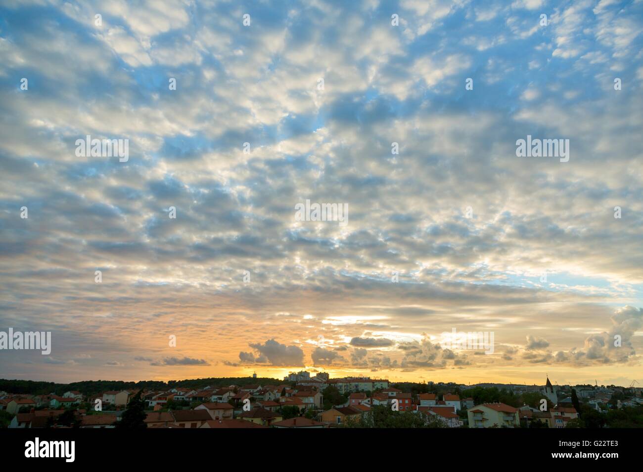 Sunset over village Stock Photo - Alamy