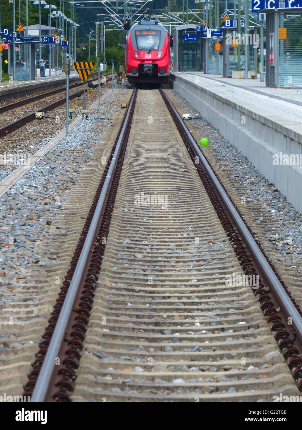 Train tracks with locomotive in background Stock Photo - Alamy