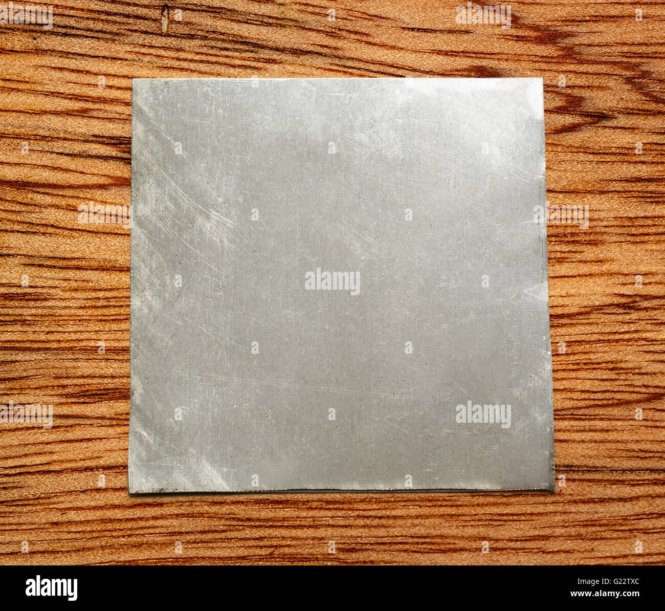 Blank square metal plate on wooden background Stock Photo - Alamy