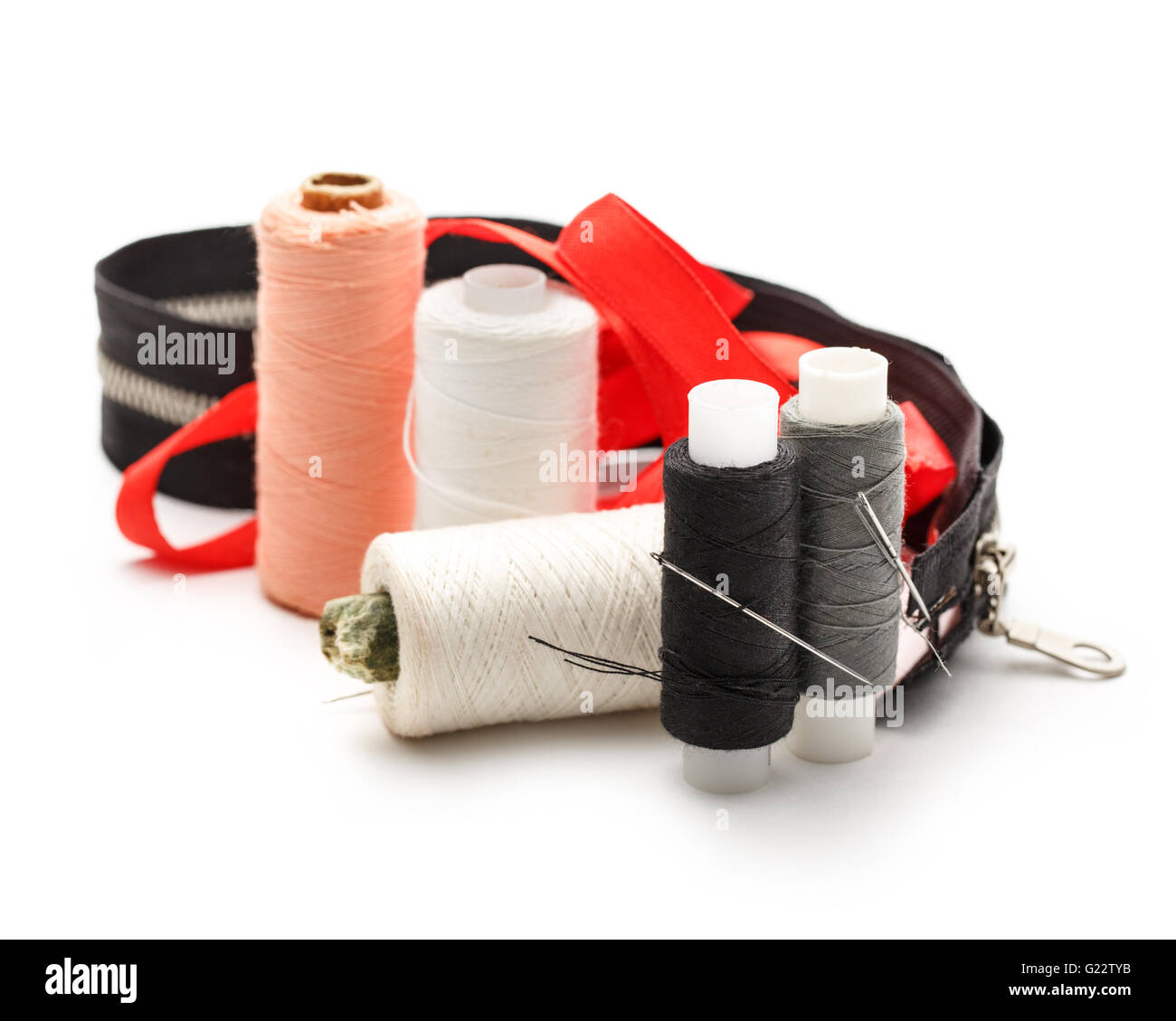 Thread bobbins and needles on white background Stock Photo - Alamy