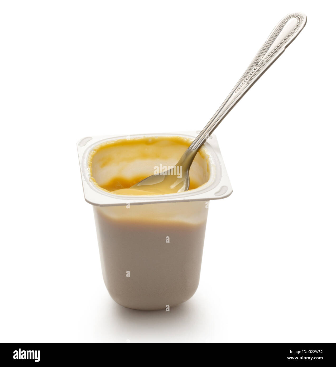 Open yogurt in pot with metal spoon closeup Stock Photo - Alamy