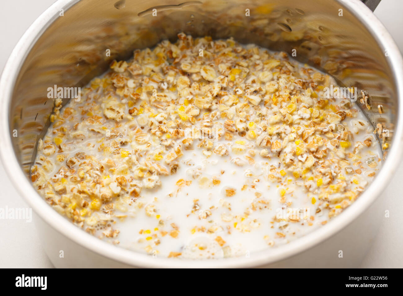 Cooking healthy porridge in metal pot closeup Stock Photo - Alamy