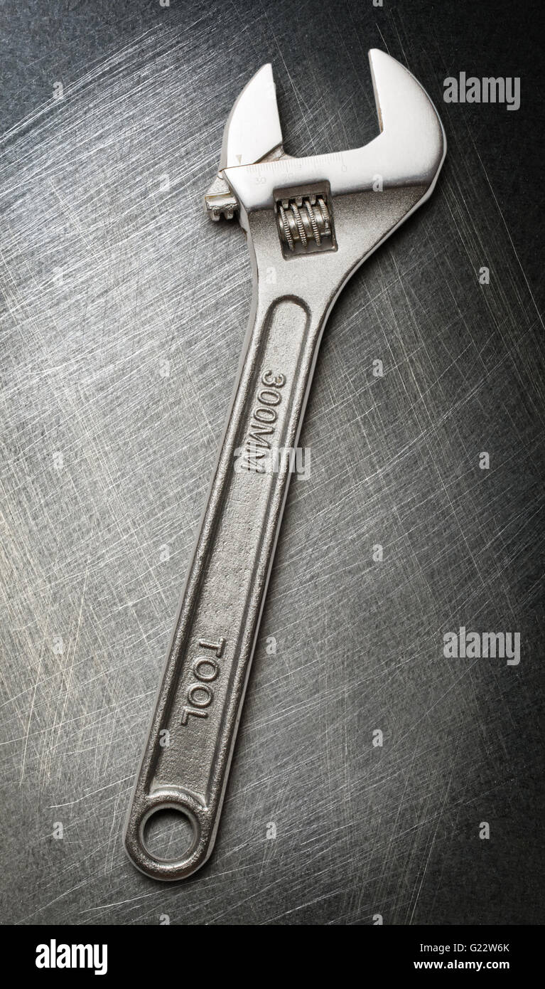 Metallic spanner on the steel background closeup Stock Photo - Alamy