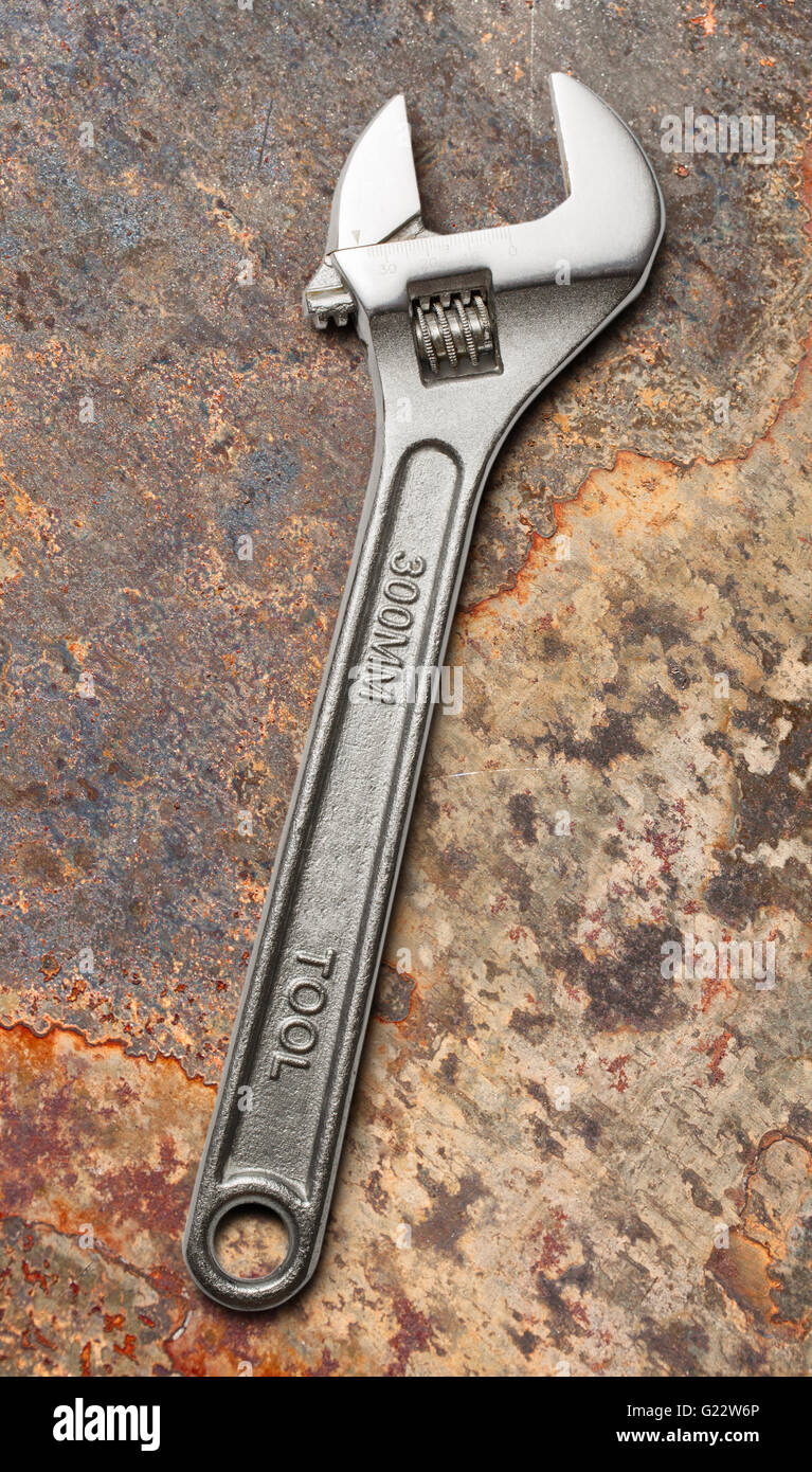 Metallic spanner on the rusty background closeup Stock Photo - Alamy