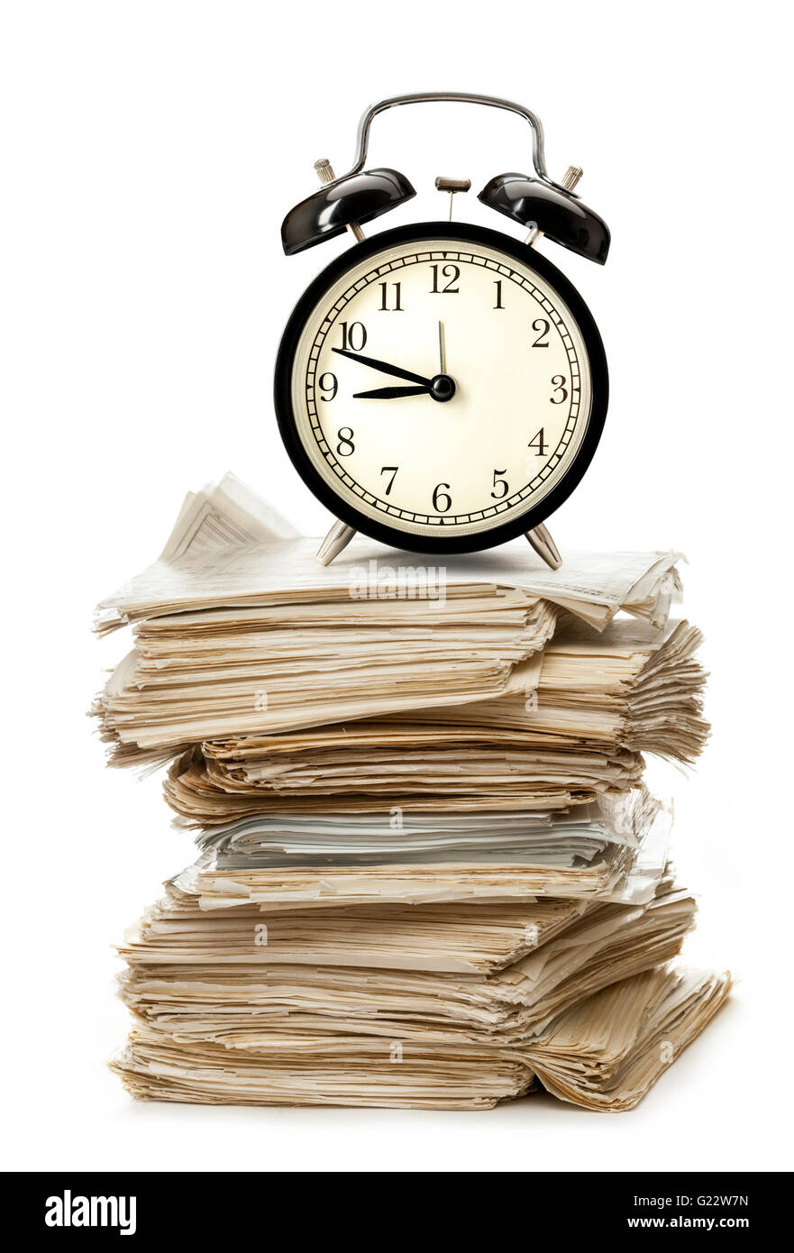 Stack of old paper documents and alarm clock Stock Photo - Alamy