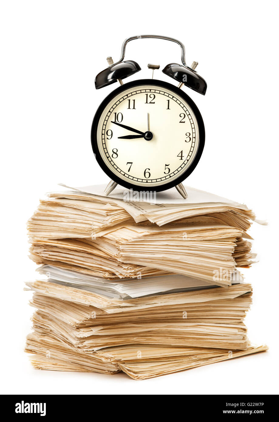 Stack of old paper documents and alarm clock Stock Photo - Alamy