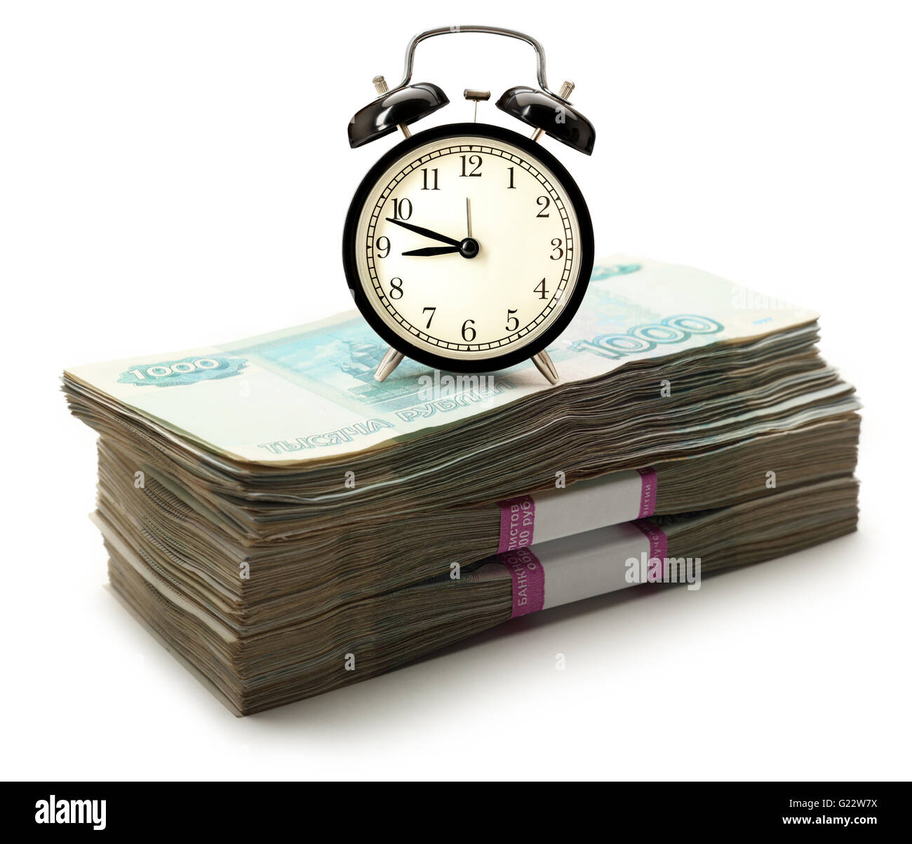Pile of money in wrapper and alarm clock Stock Photo - Alamy
