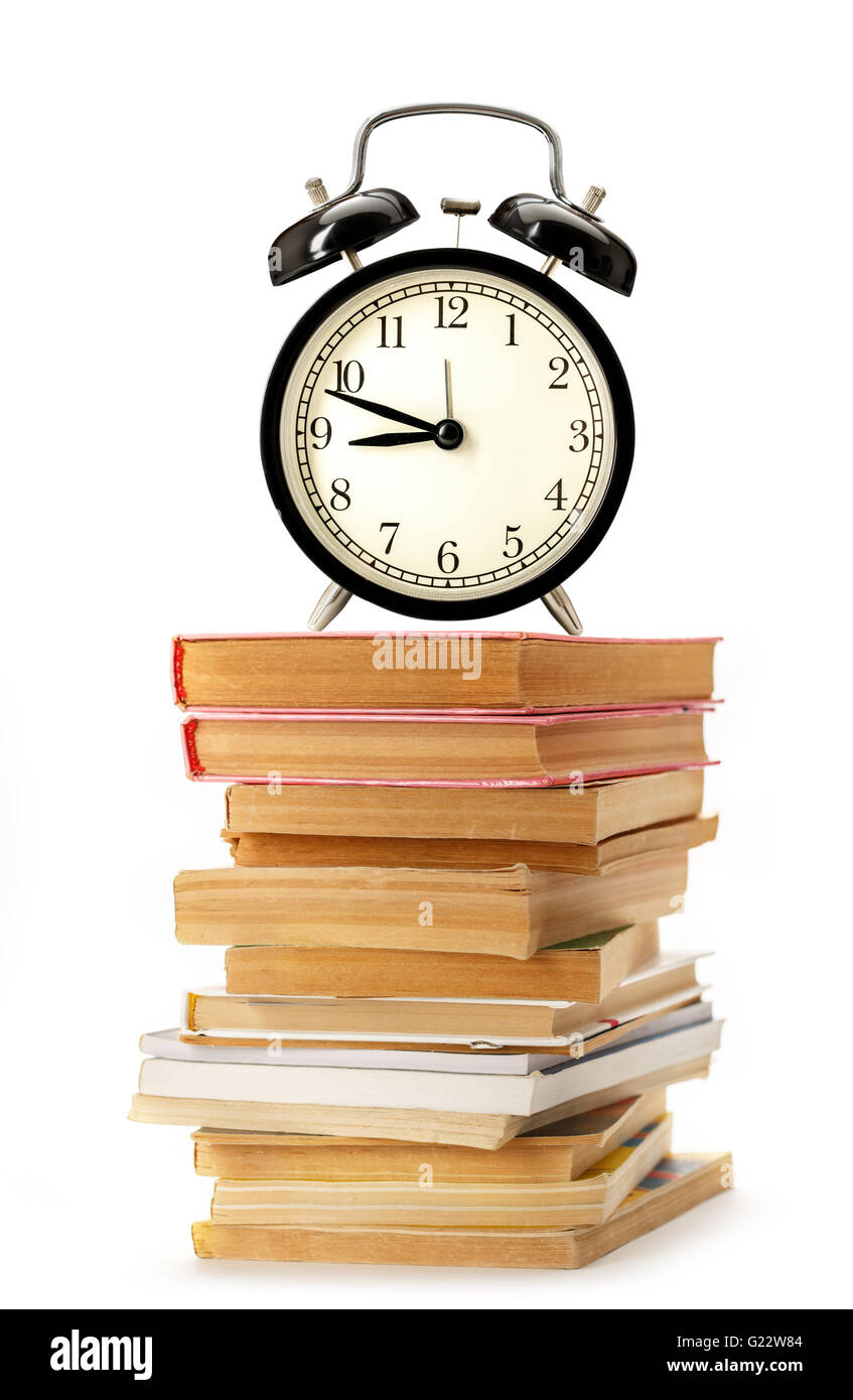 Stack of old books and magazines with alarm clock Stock Photo - Alamy