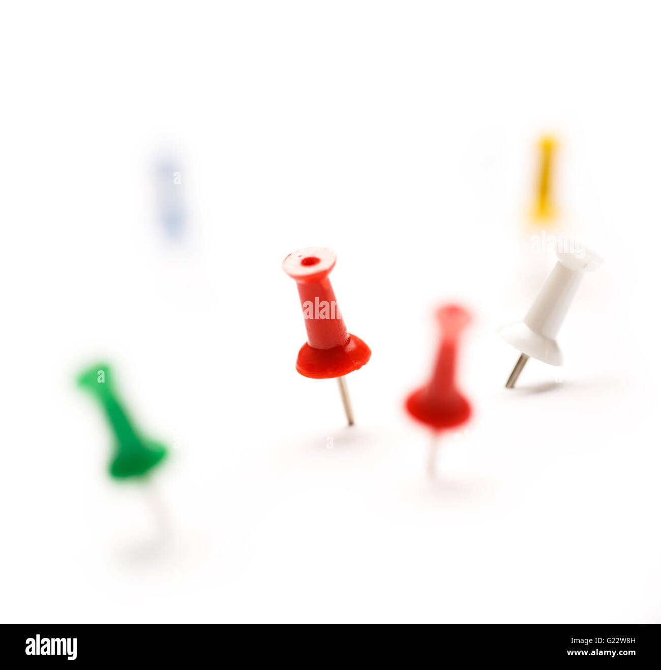 Colorful paper pins attached to white paper Stock Photo - Alamy