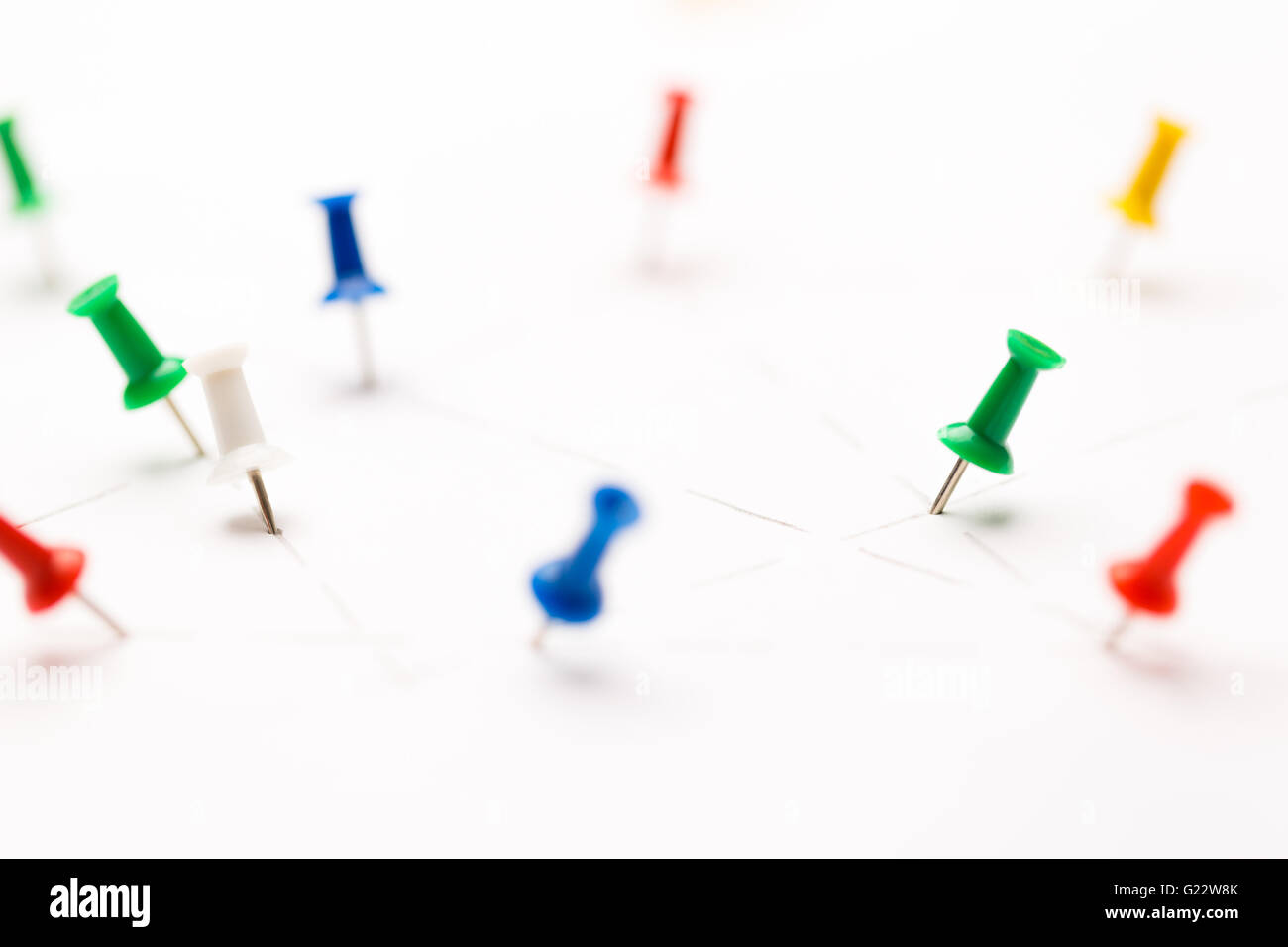 Colorful paper pins attached to white paper Stock Photo - Alamy