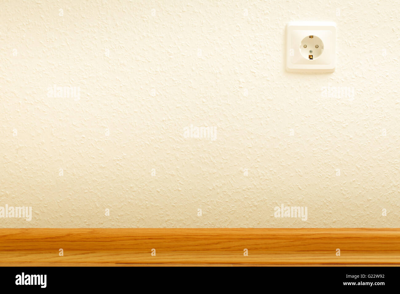 Single empty electric socket on white wall Stock Photo - Alamy
