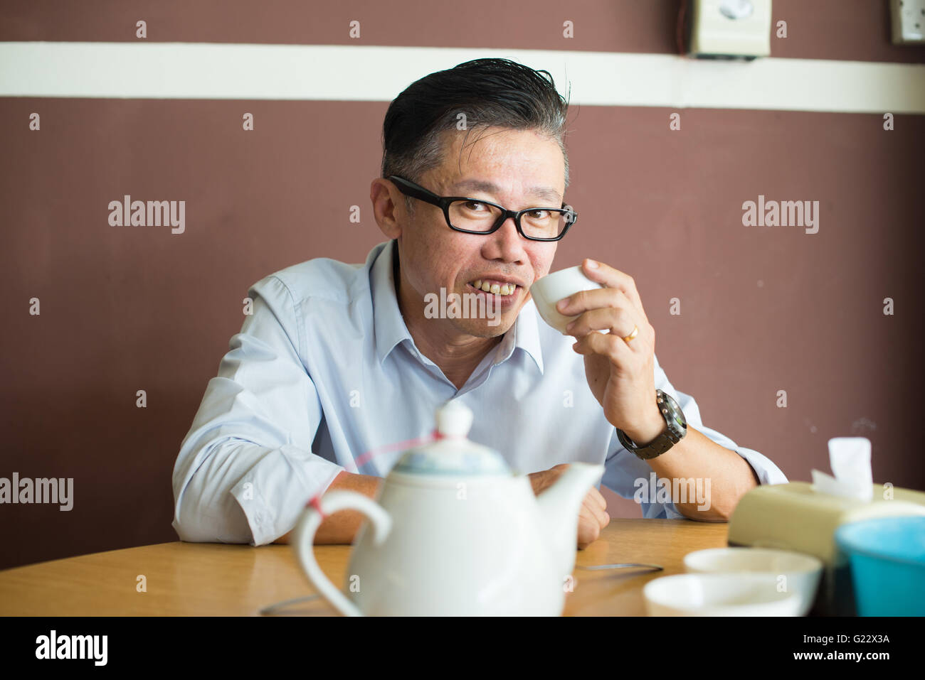 asian senior male enjoying tea Stock Photo - Alamy