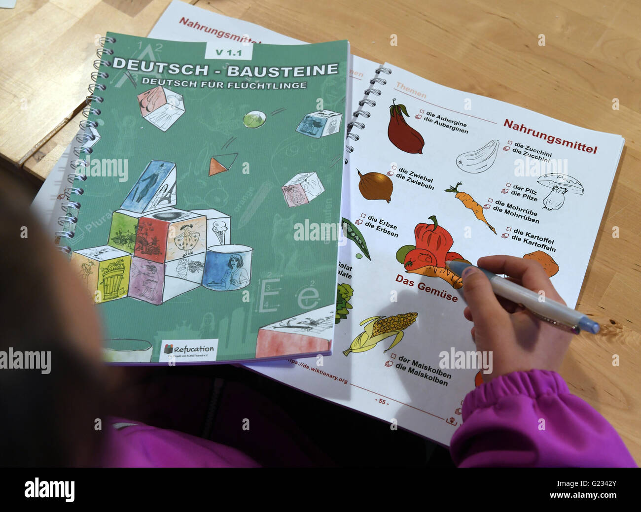 A child looks at the first edition of the free German book 'Deutsch ...