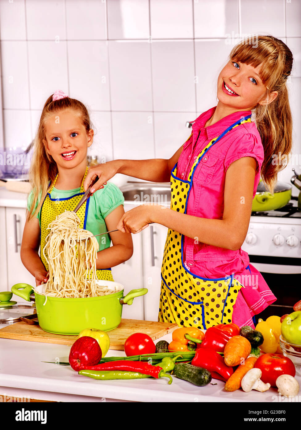 Children cooking spaghetti at kitchen Stock Photo - Alamy