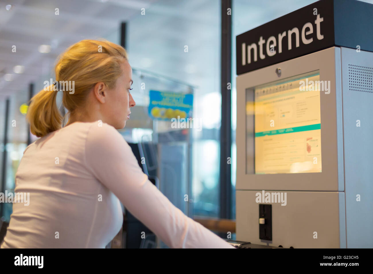 Woman public internet access point on airport Stock Photo - Alamy