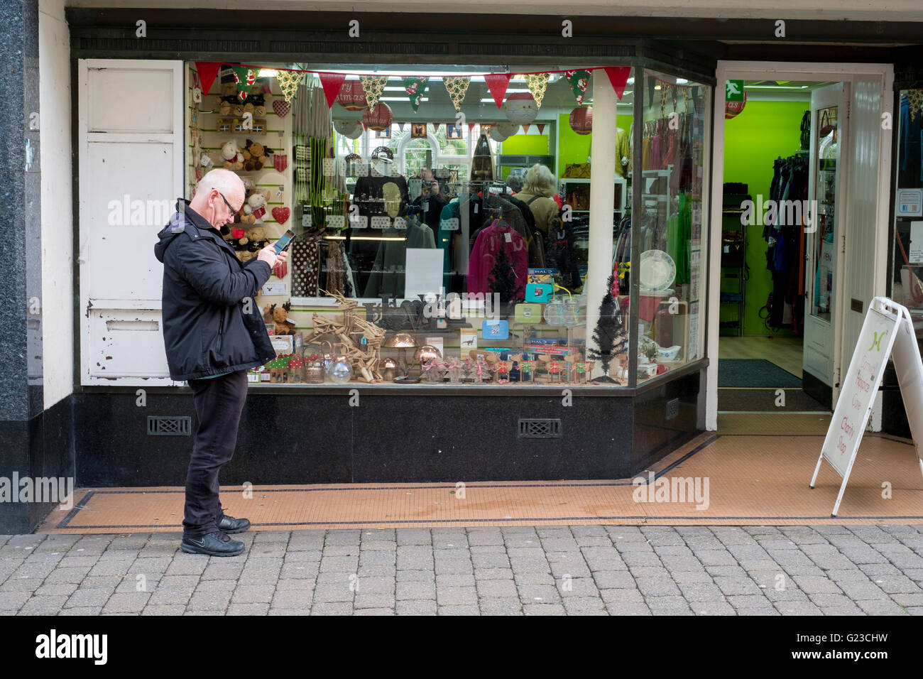 Older gentleman checks mobile phone Stock Photo - Alamy