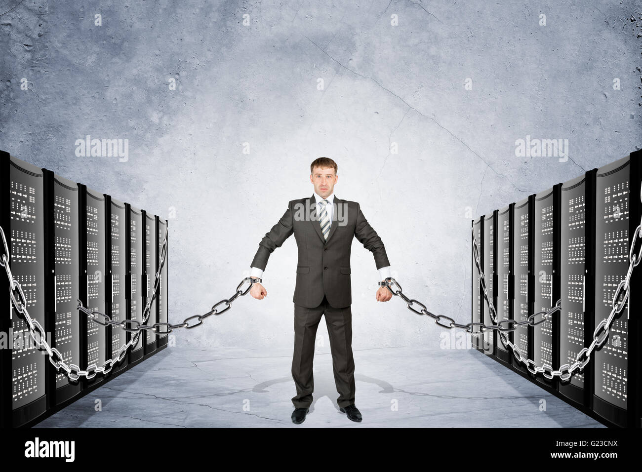 Businessman chained to iron boxes Stock Photo - Alamy