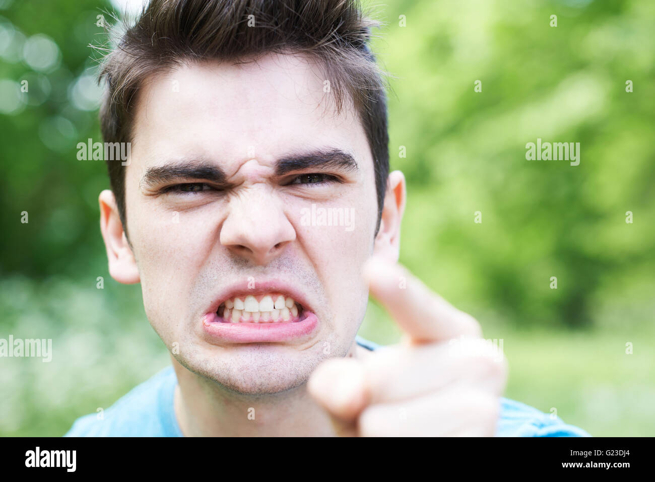 Outdoor Head And Shoulders Portrait Of Angry Young Man Stock Photo - Alamy