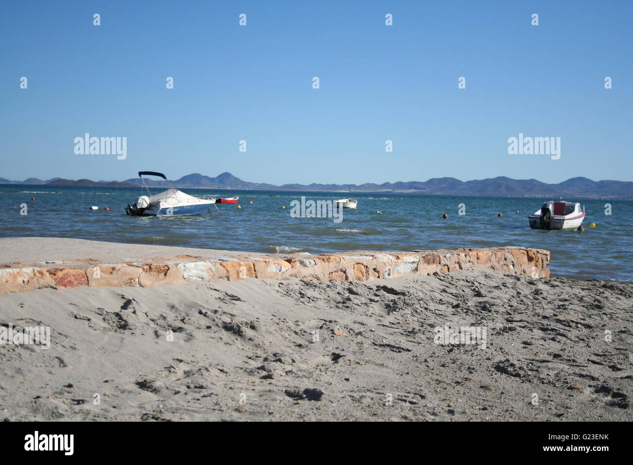 A boat in shallow waters at the beach Stock Photo - Alamy