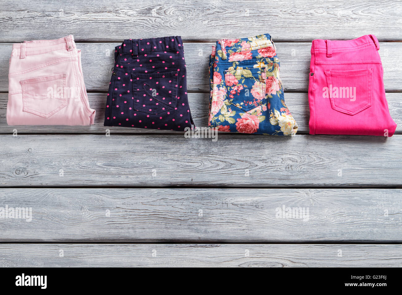 Folded pants of different color Stock Photo - Alamy