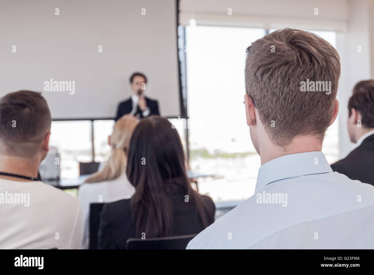 Business man speaking at presentation in microphone in office Stock ...