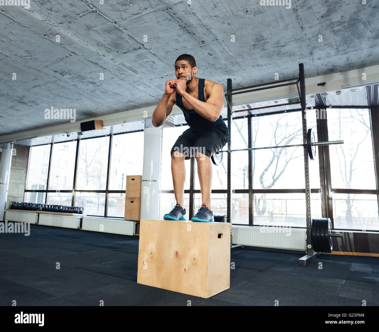 Healthy fitness guy doing exercise with a fit box in a gym Stock Photo ...