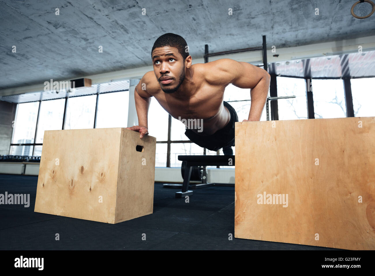 Healthy fitness man doing push-ups in the gym using sports equipment ...