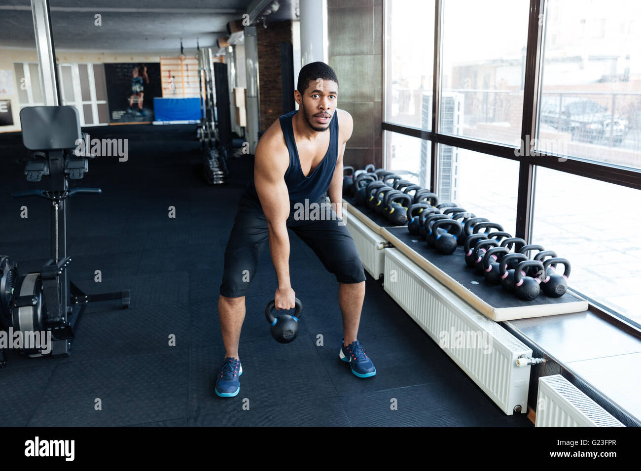 Healthy fitness man doing a weight training by lifting a heavy ...