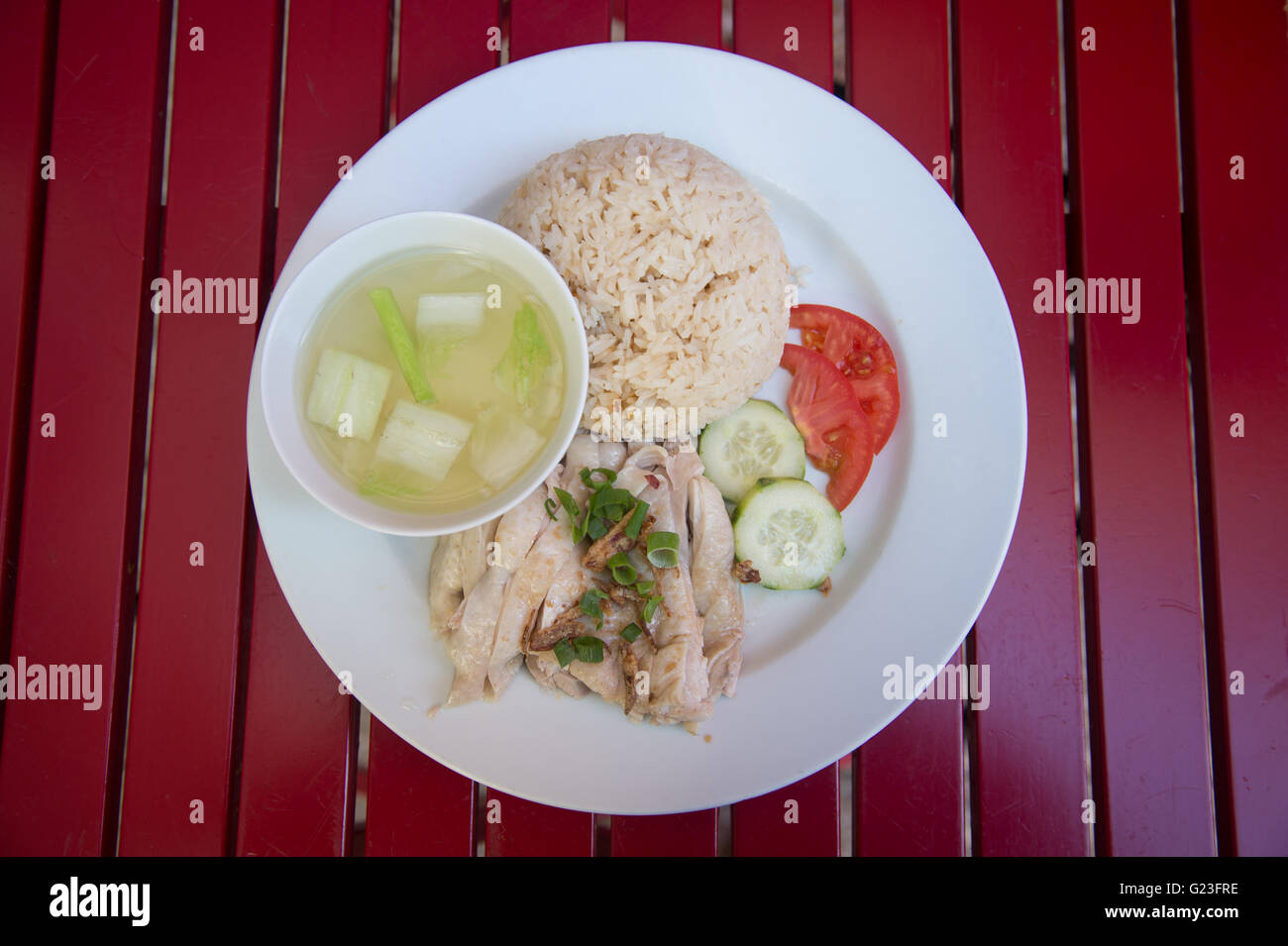 Hainanese chicken rice, Poached chicken with aromatic rice, cucumber ...