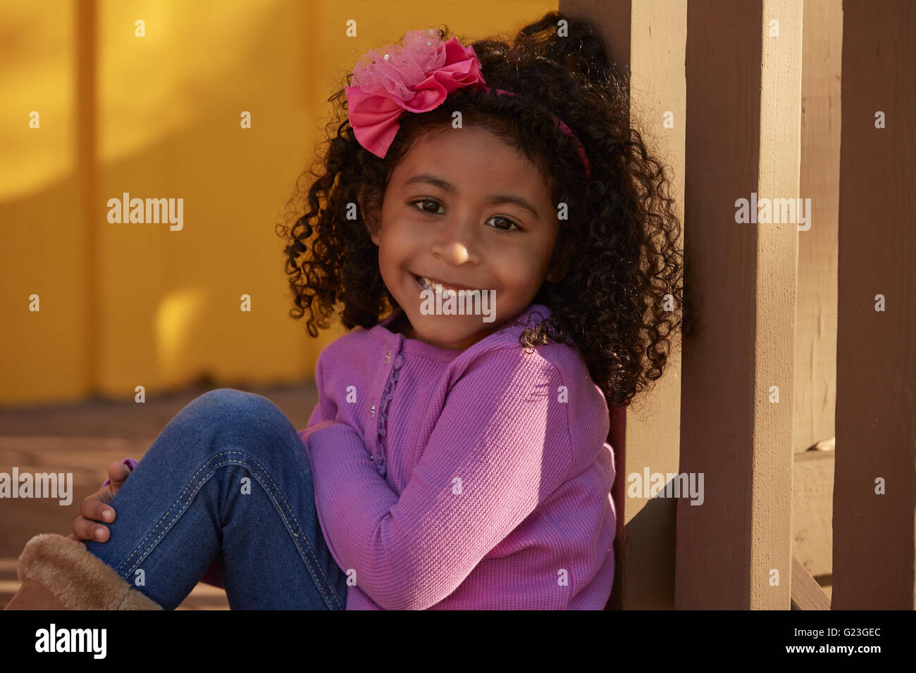 Happy toddler kid girl portrait in a park fence latin ethnicity Stock ...