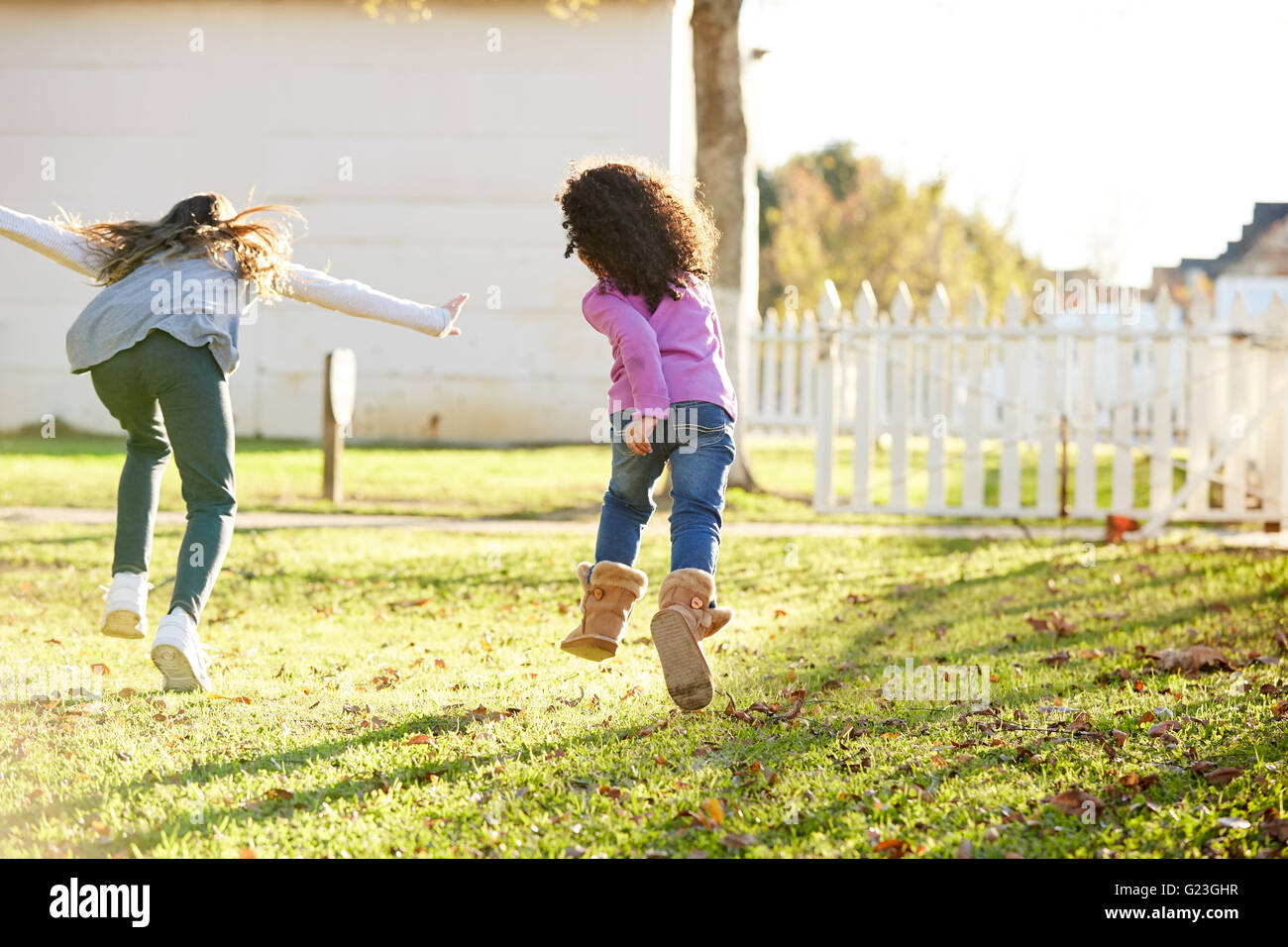 Multi ethnic kid girls playing running in park outdoor Stock Photo - Alamy