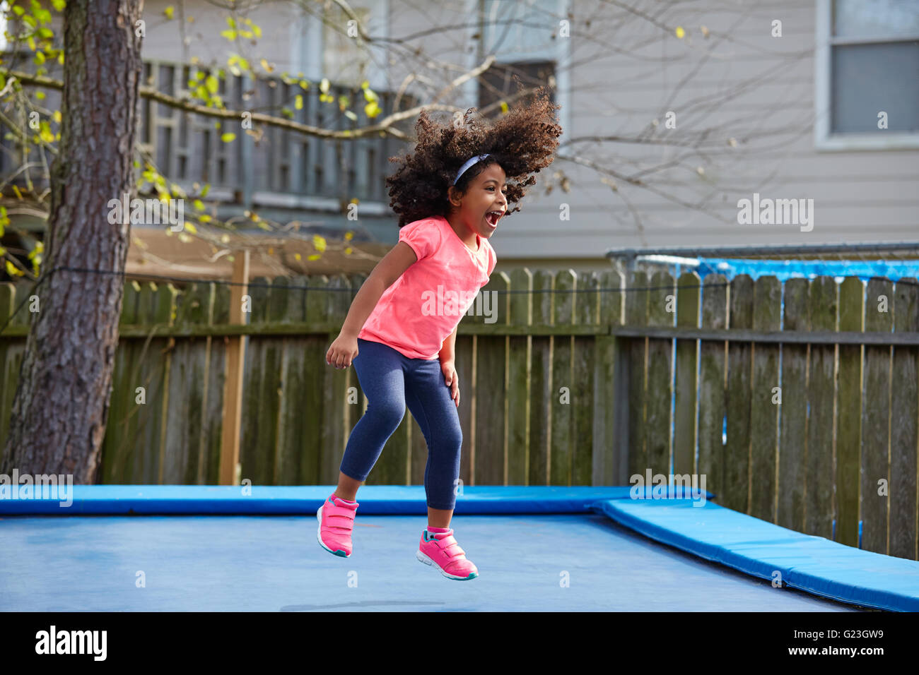 Little girl jumping on the trampoline (bungee jumping Stock Photo - Alamy