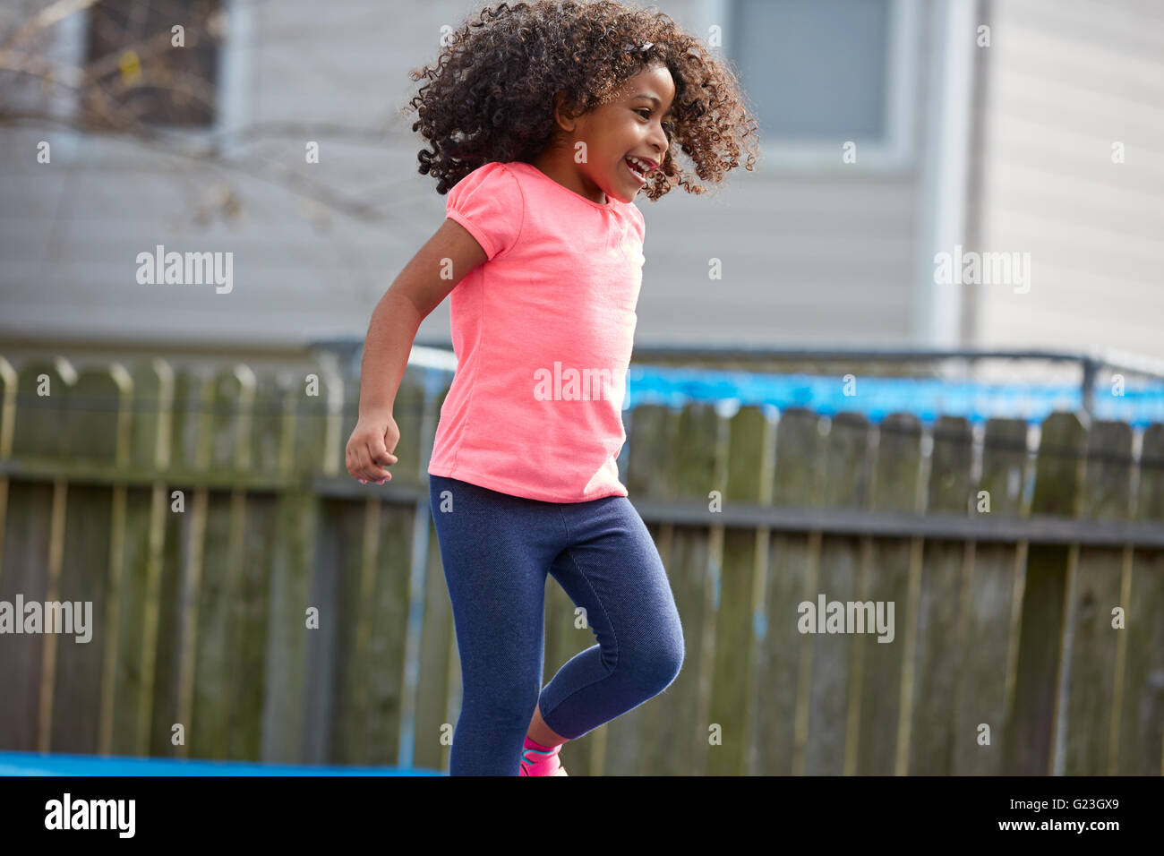 Happy child kid girl jumping hi-res stock photography and images - Alamy