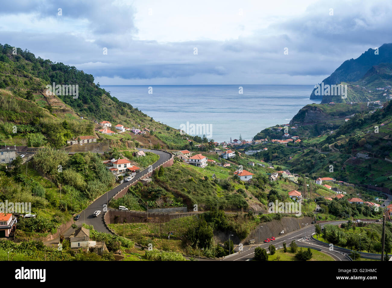 Typical landscape of Madeira island, serpentine mountain road, houses ...