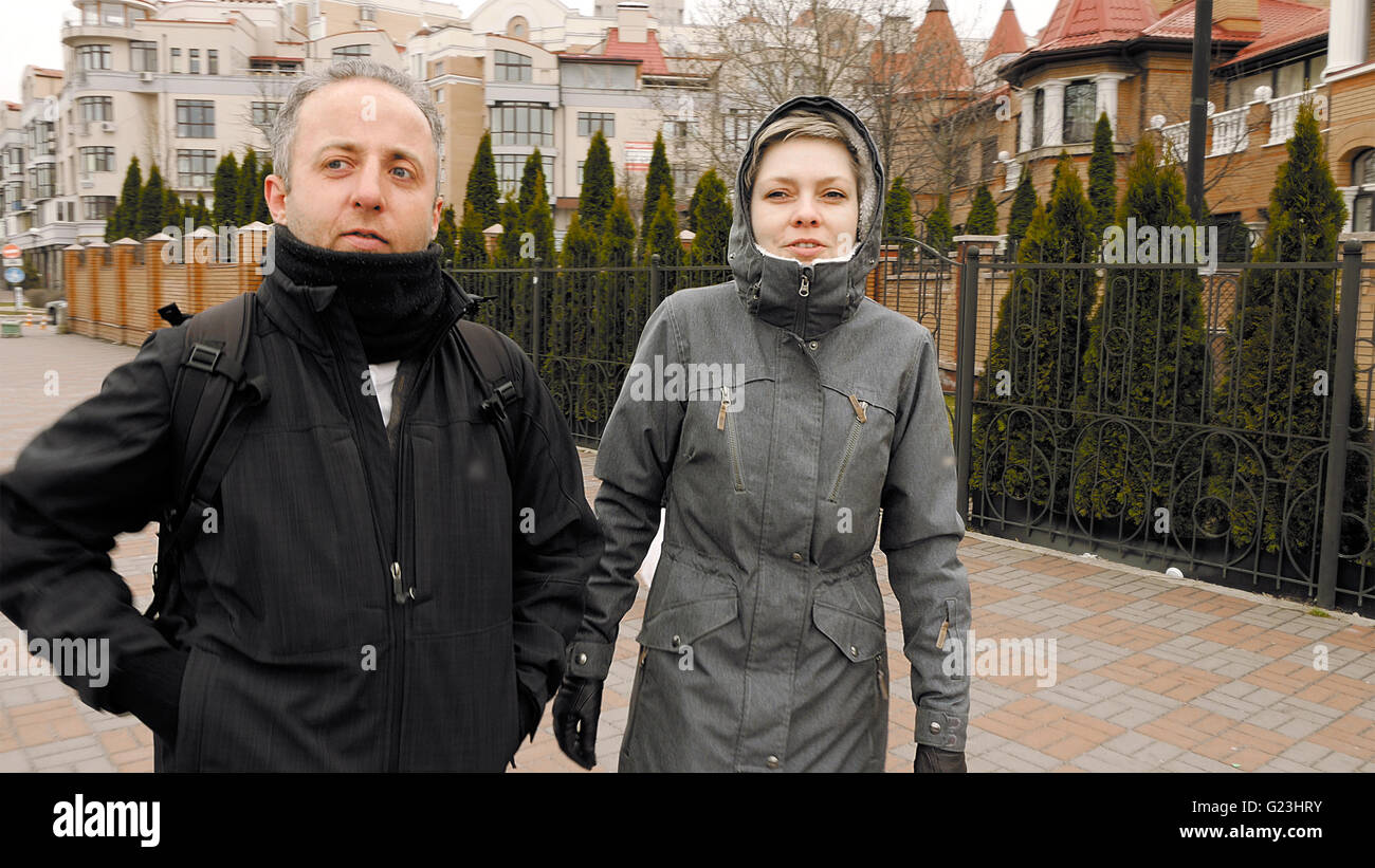 Young couple walk through city streets together Stock Photo - Alamy