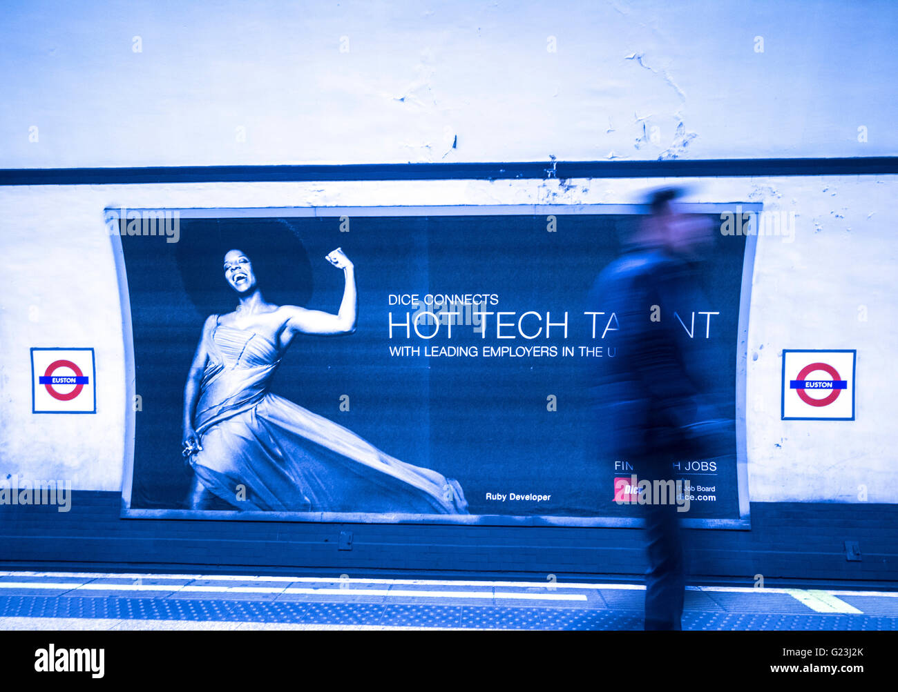 Passenger walking past advertisement in London Underground Stock Photo ...