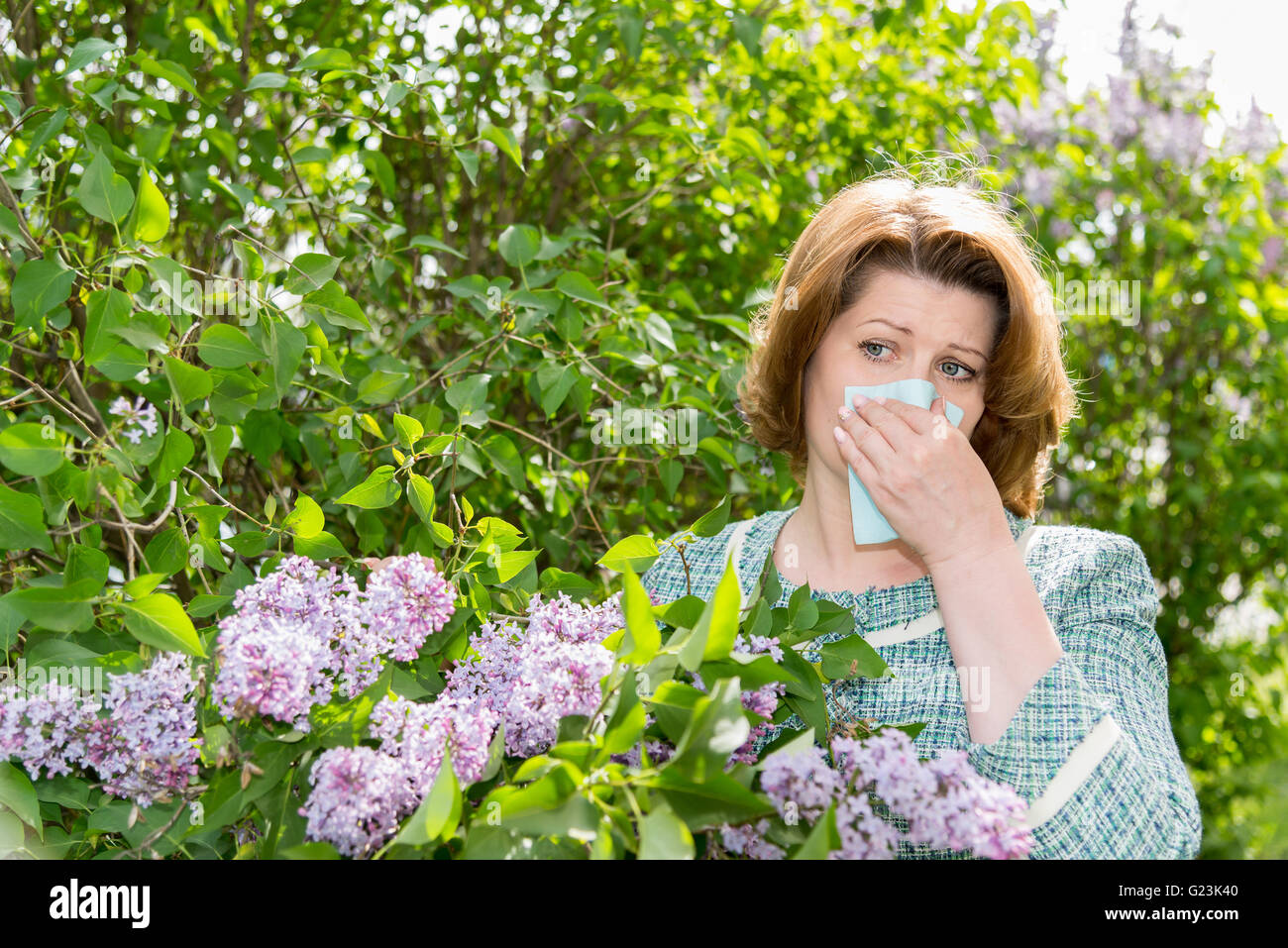 Woman suffering from pollen allergy about lilacs Stock Photo - Alamy