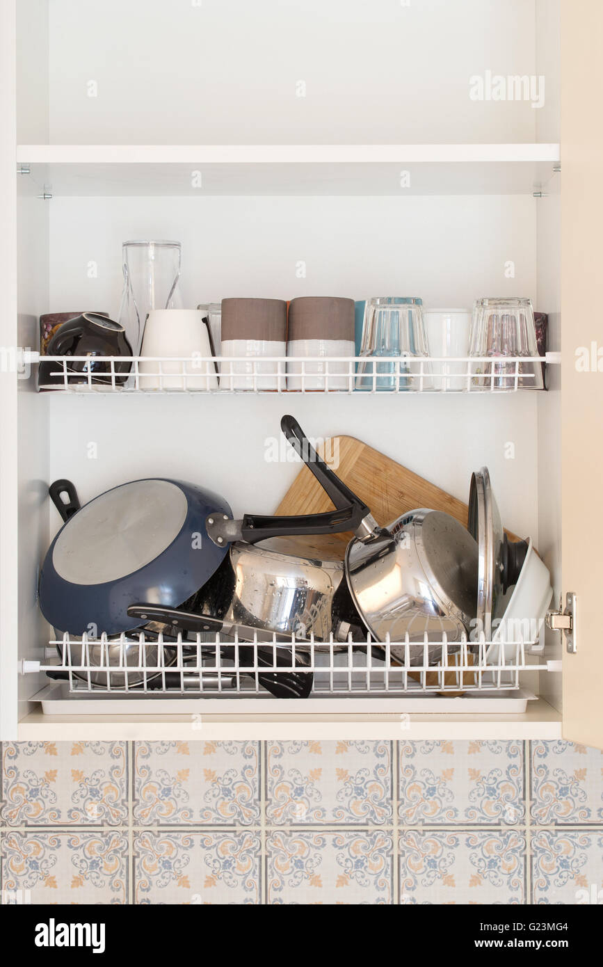 wet dishes in the dish draining closet Stock Photo - Alamy