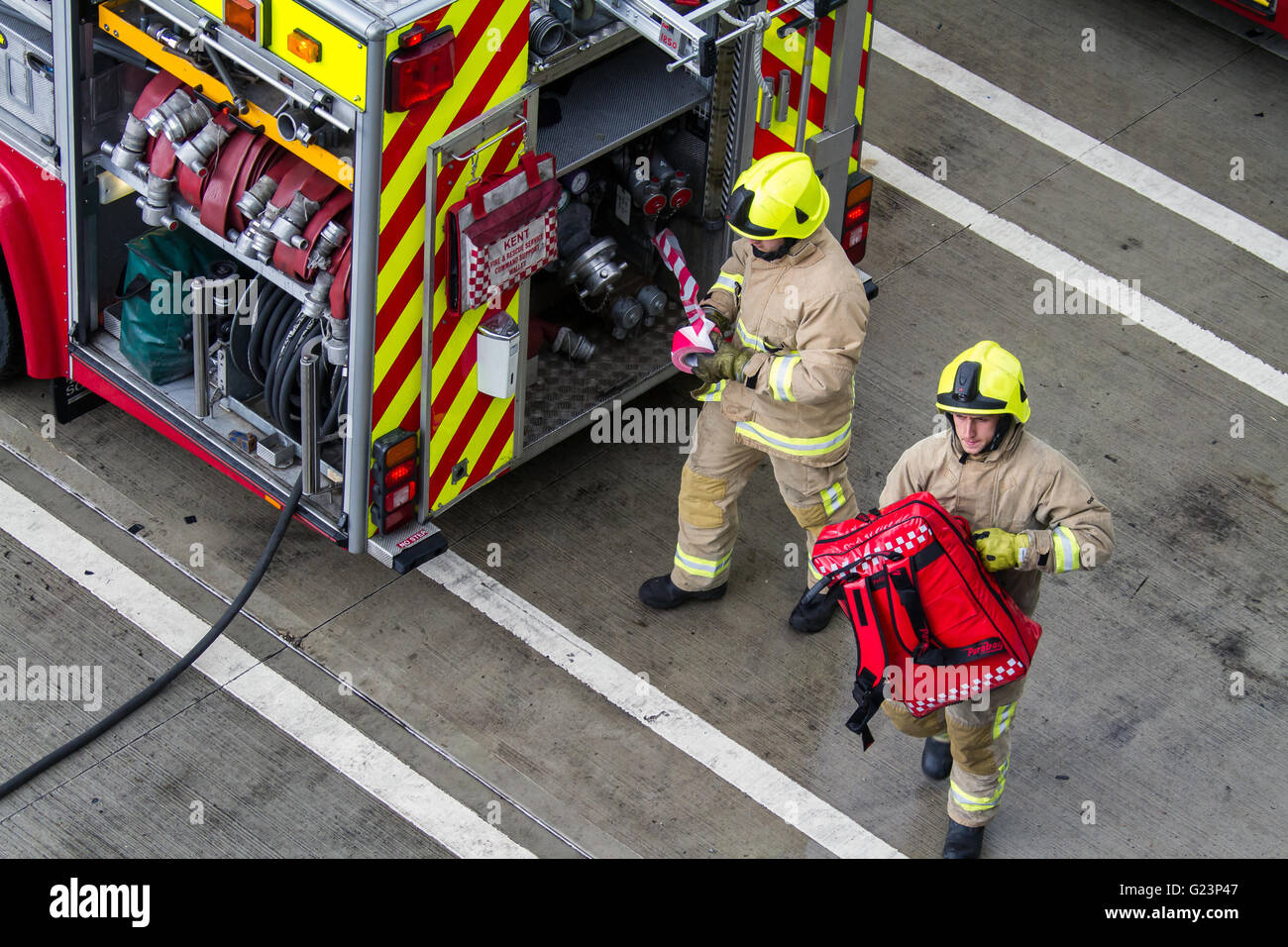 Firefighters with Trauma bag prepare to treat a simulated casualty ...