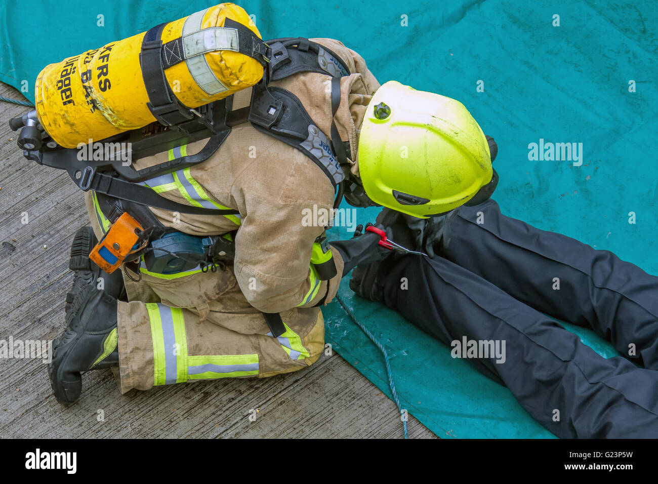 Firefighter prepares to treat a simulated casualty during a training ...