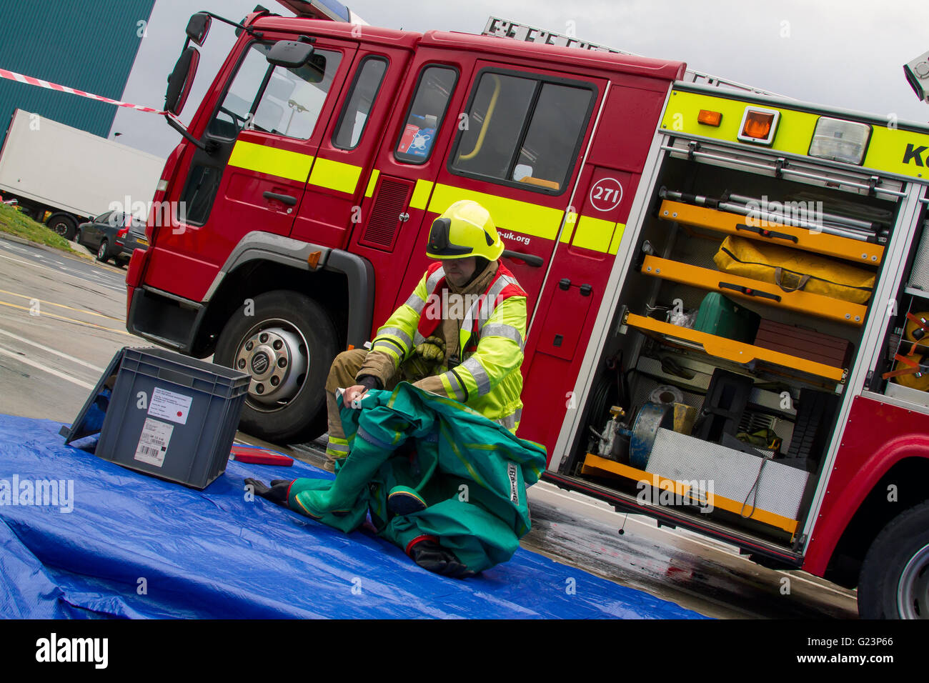 Firefighter prepares a Gas Tight Suit during a chemical incident ...