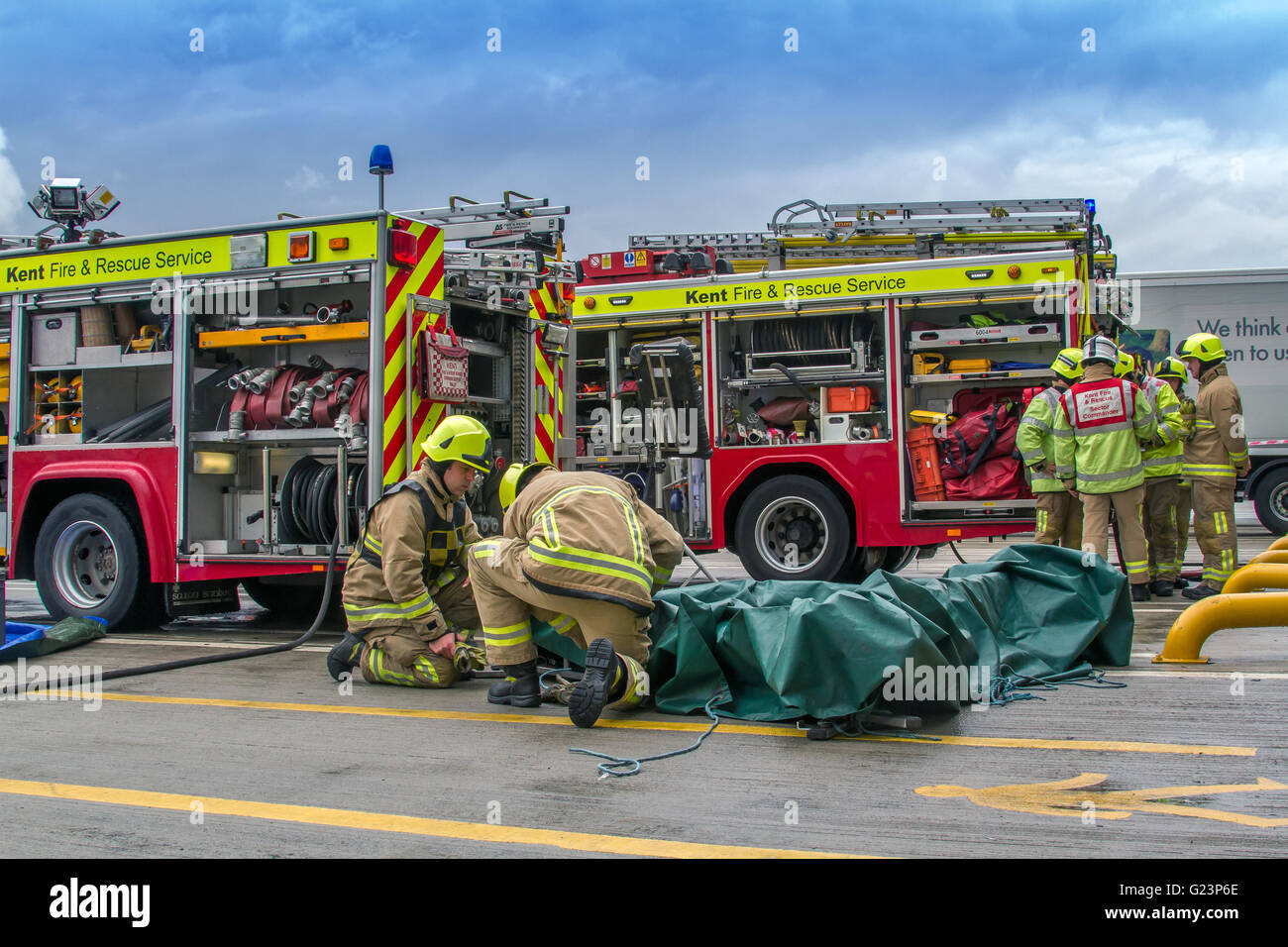 Fire fighters constructing a a dam using a salvage sheet and triple ...