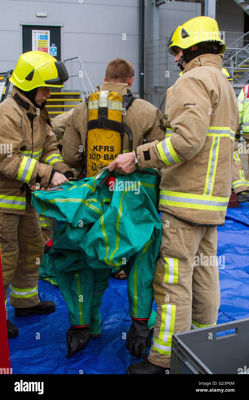 Firefighters assist colleague don Gas Tight Suit during a chemical ...