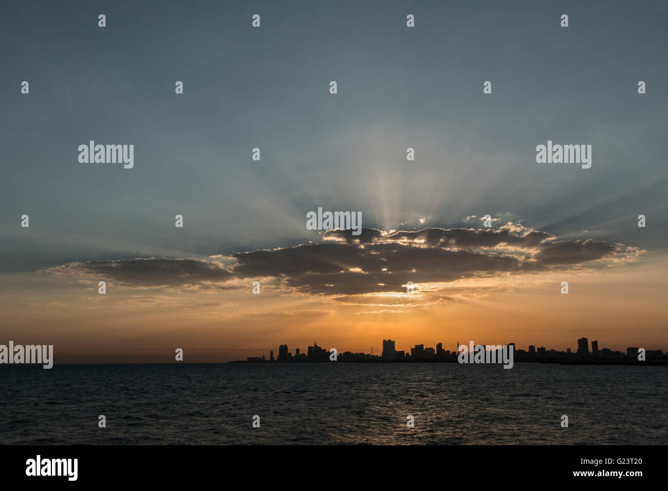 Sunrise in Kuwait, with cloud and silhouette buildings Stock Photo - Alamy